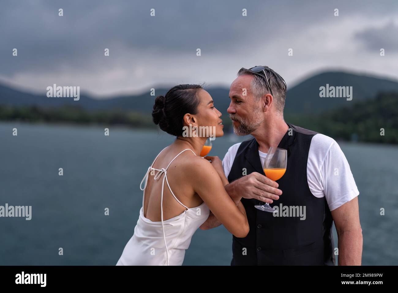 Romantic couple in love have fun sailing in the sea standing on yacht ...