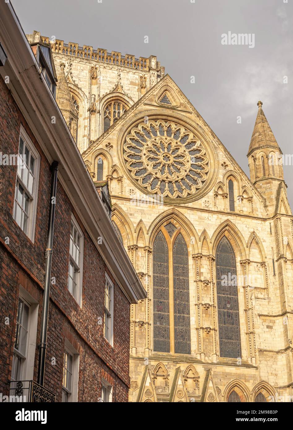 A view of the south entrance of York Minster from a brick building. A ...