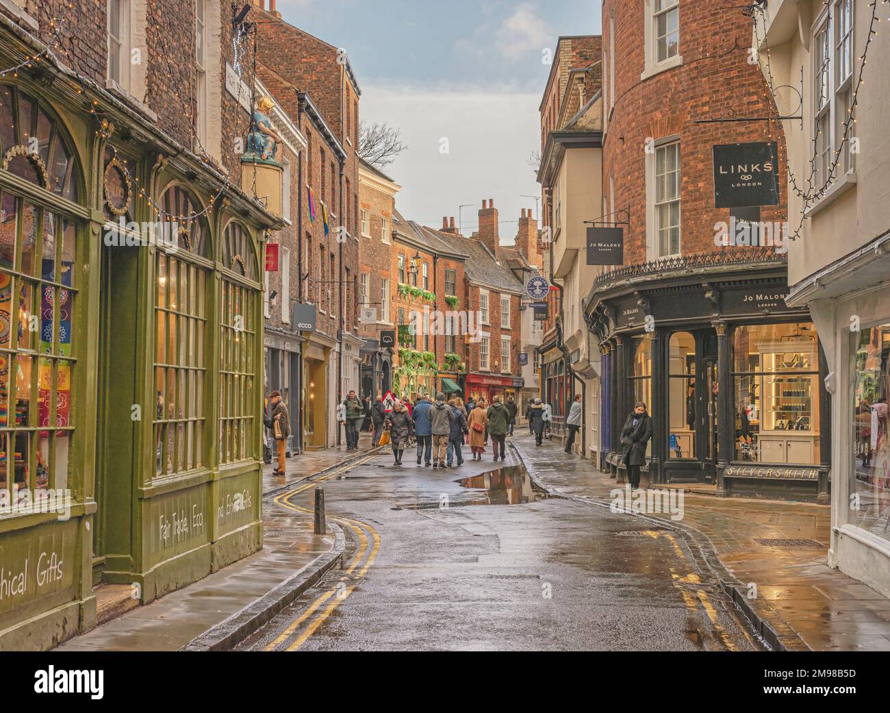 An ancient street in York. Old buildings are on each side and sunlight ...