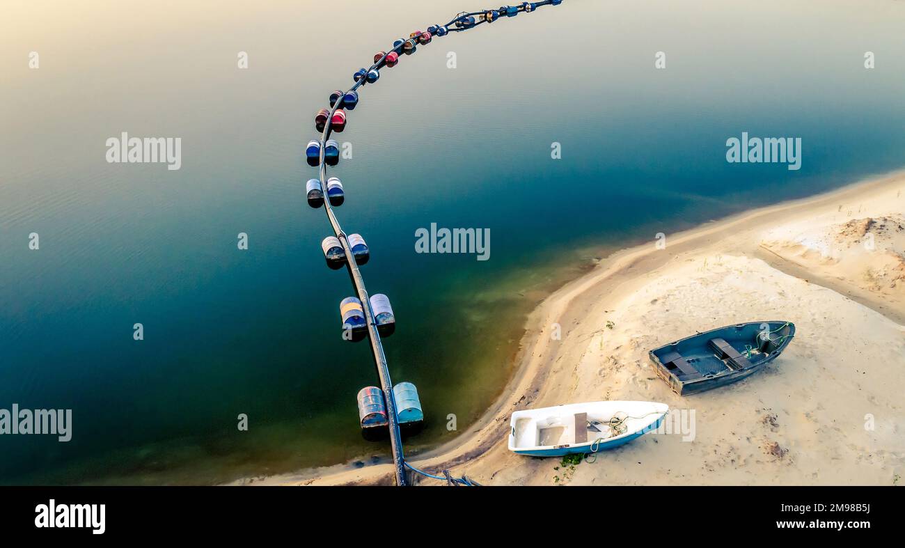 Aerial view of blue tube with barrels on the lake Stock Photo - Alamy