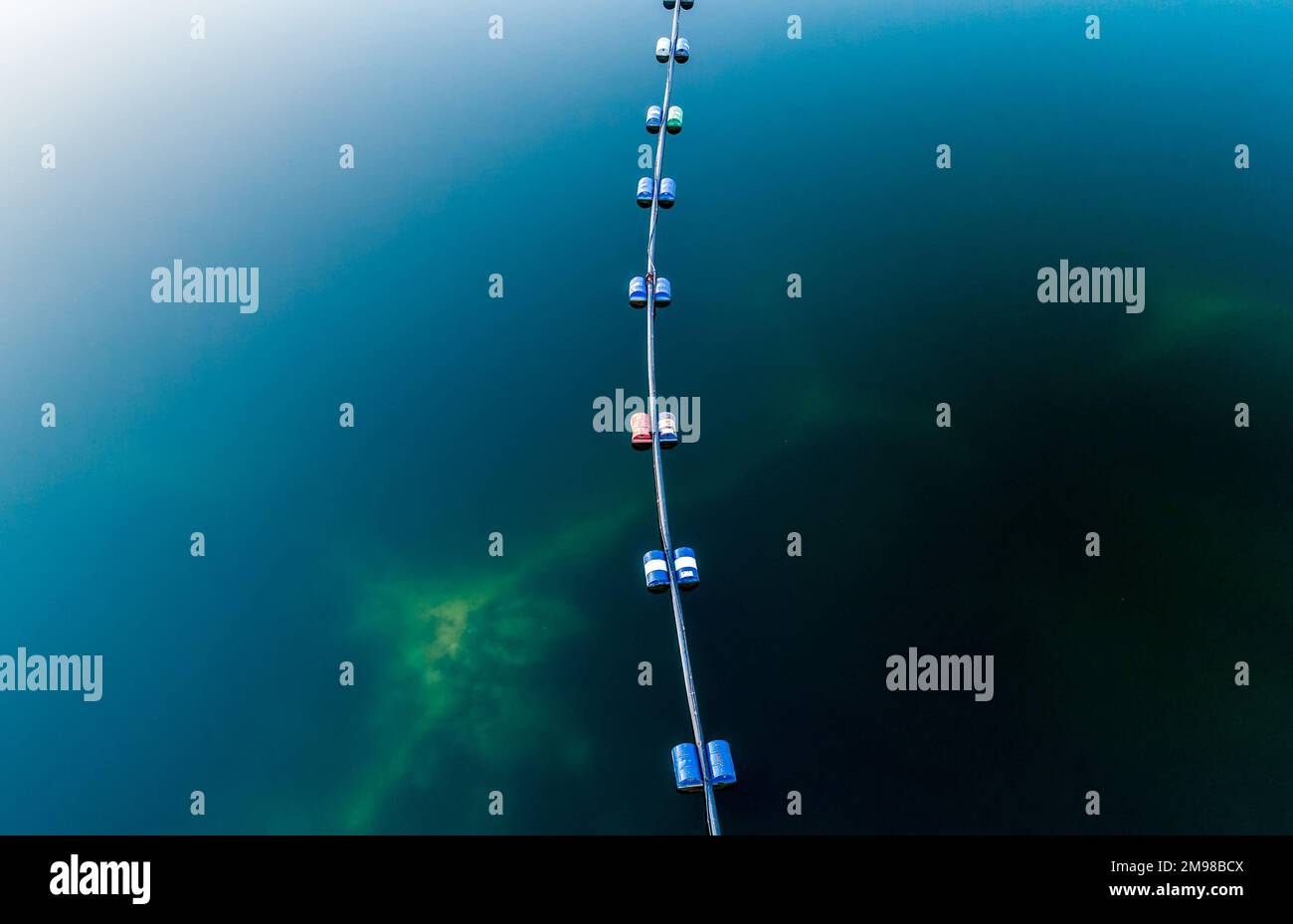Aerial view of blue tube with barrels on the lake Stock Photo - Alamy