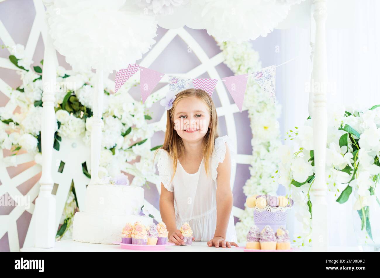 Pretty smiling little girl in the candy bar Stock Photo - Alamy