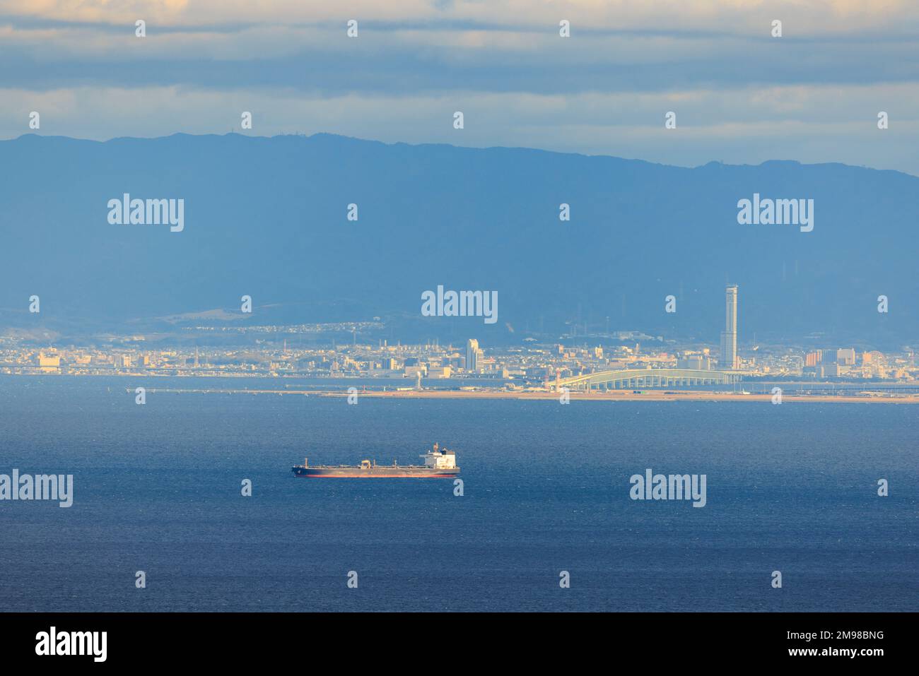 Cargo Ship Sails to Port in Osaka Bay by Rinku Gate Tower on Sunny Day ...