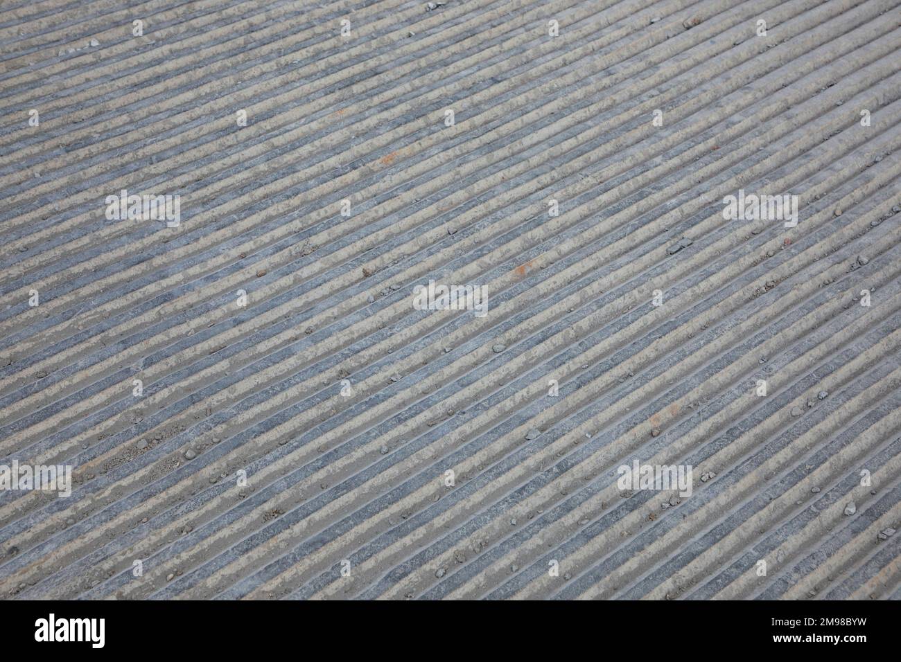 Gray cement surface texture background with channels for water flow ...