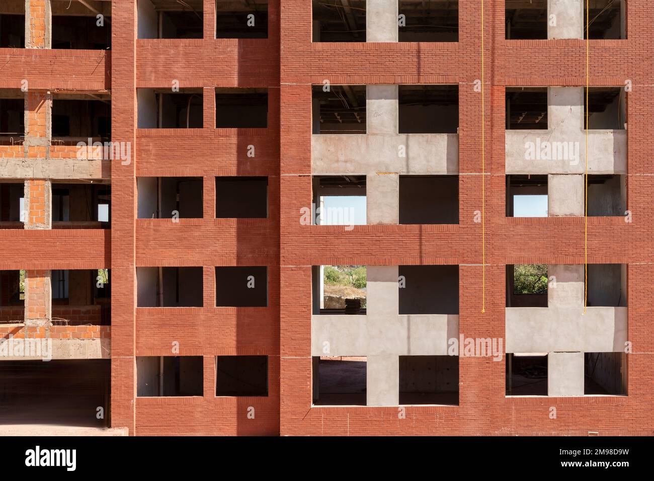 building facade pattern under concrete construction with red partition ...
