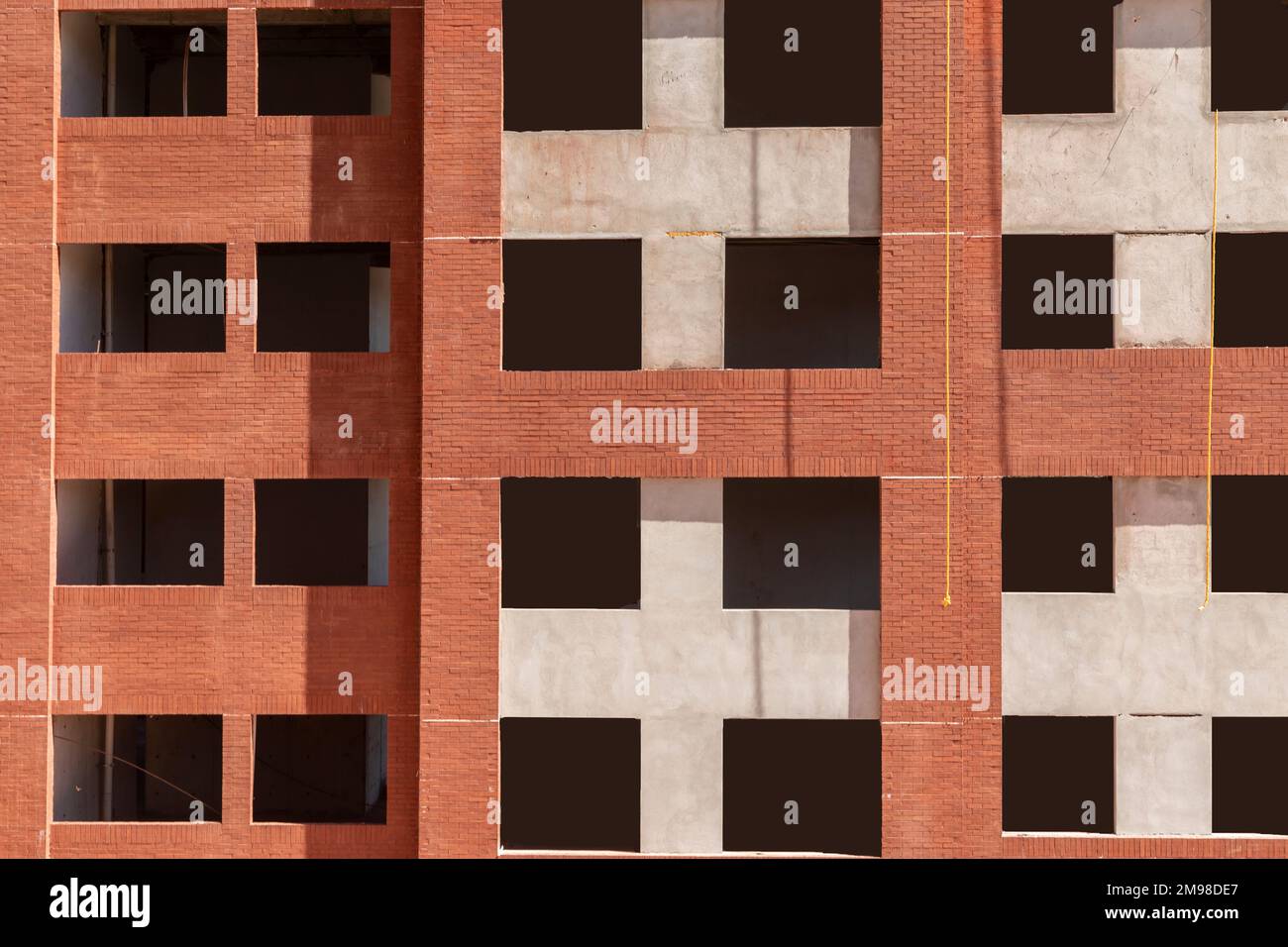 building facade pattern under concrete construction with red partition ...