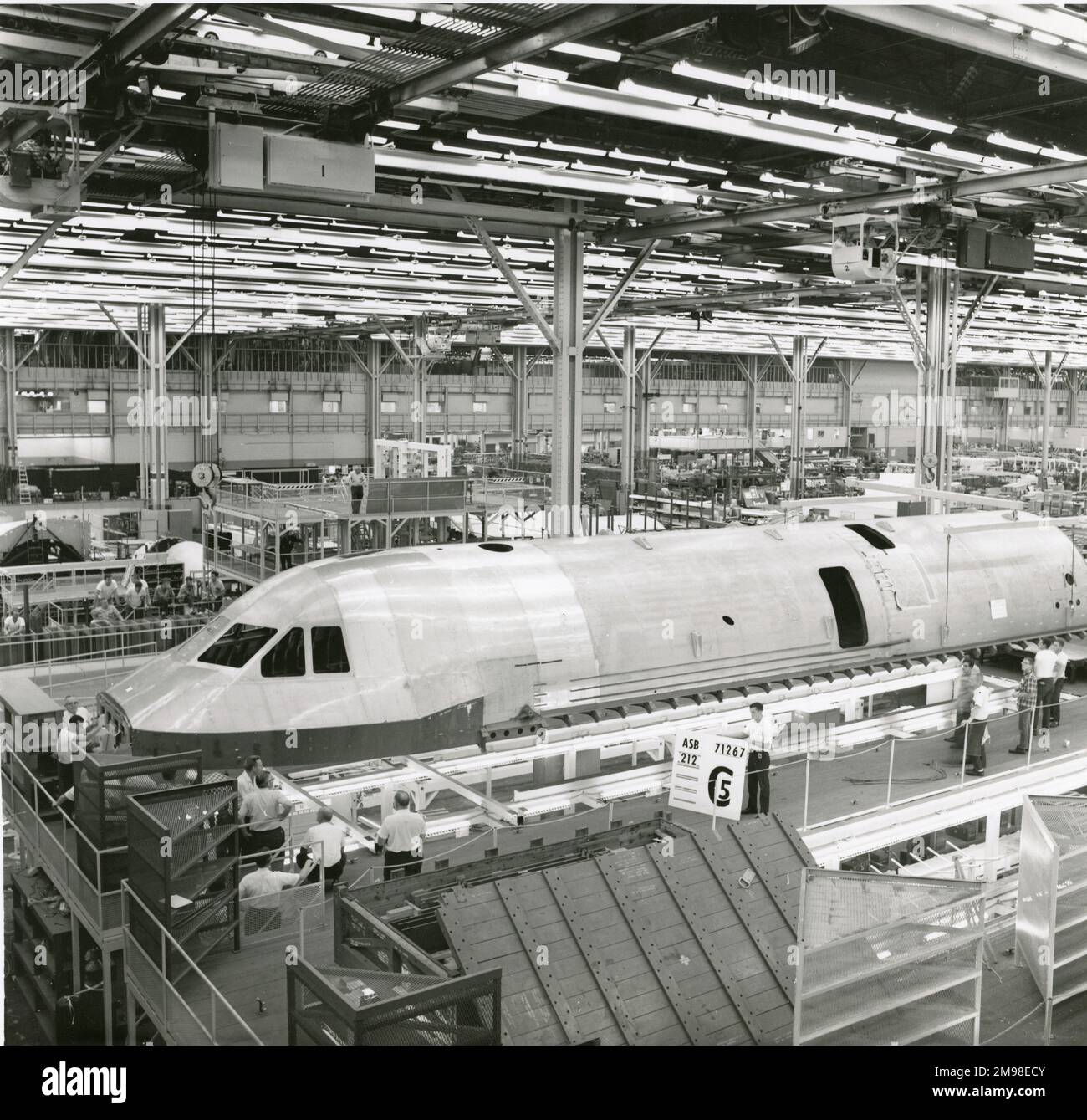 Overhead cranes at Lockheed-Georgia move the first Lockheed C-5A Galaxy ...