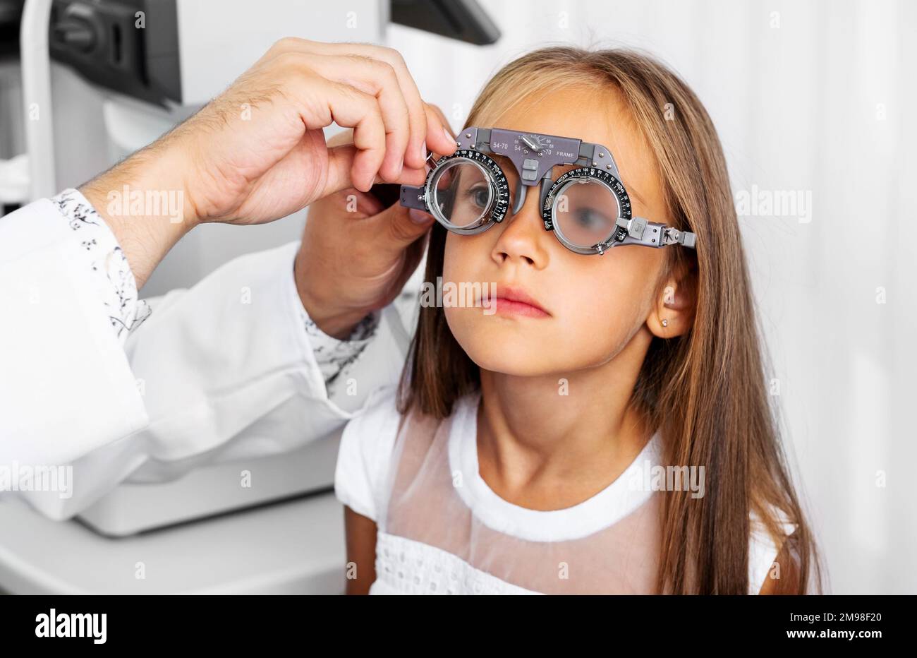 Doctor holding special eye equipment Stock Photo - Alamy