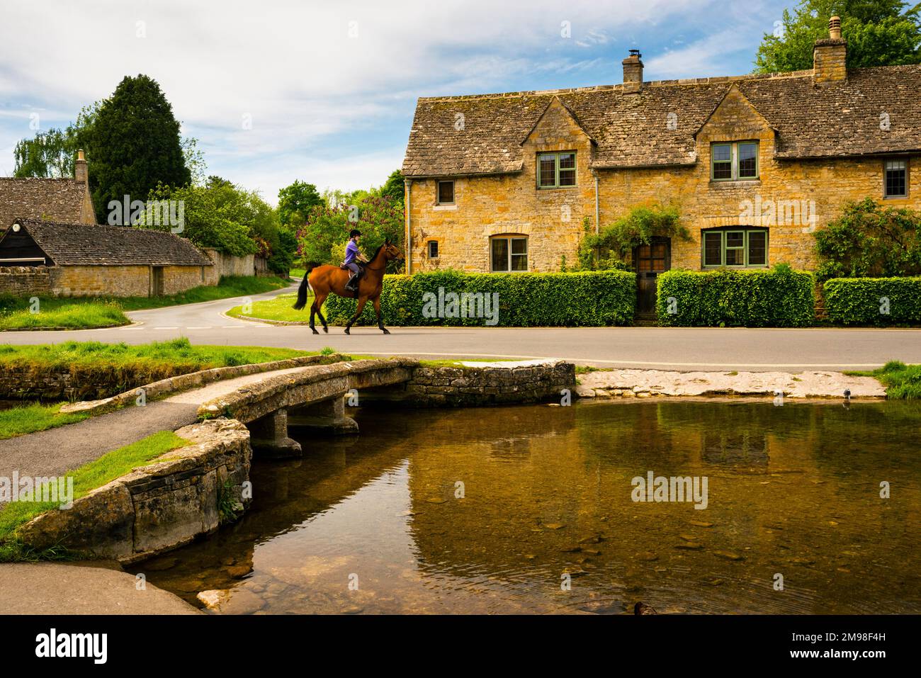 Cotswold Village of Lower Slaughter stone footbridge over the River Eye ...