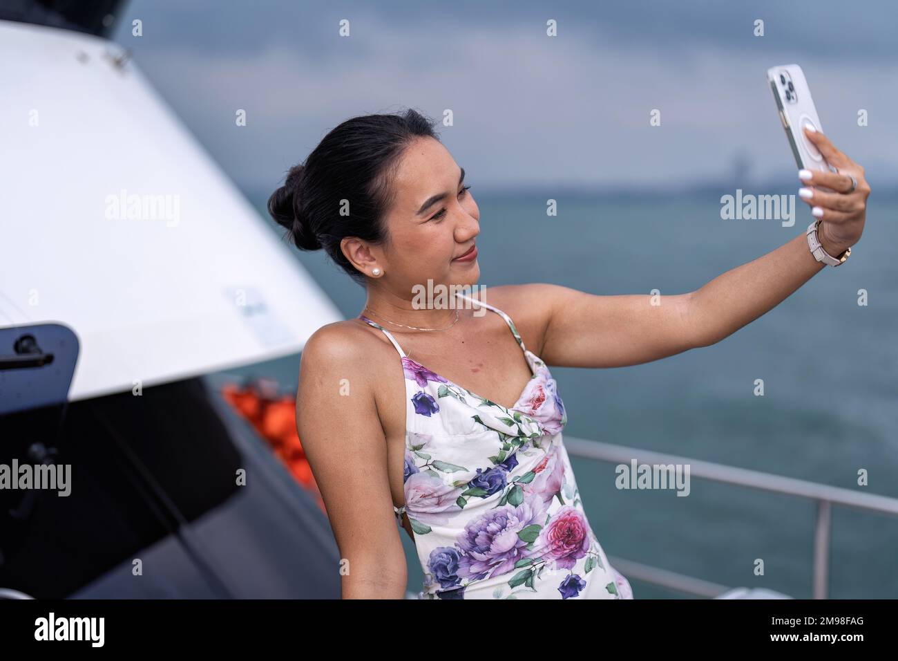Beautiful girl have fun sailing in the sea sitting on yacht deck enjoy ...