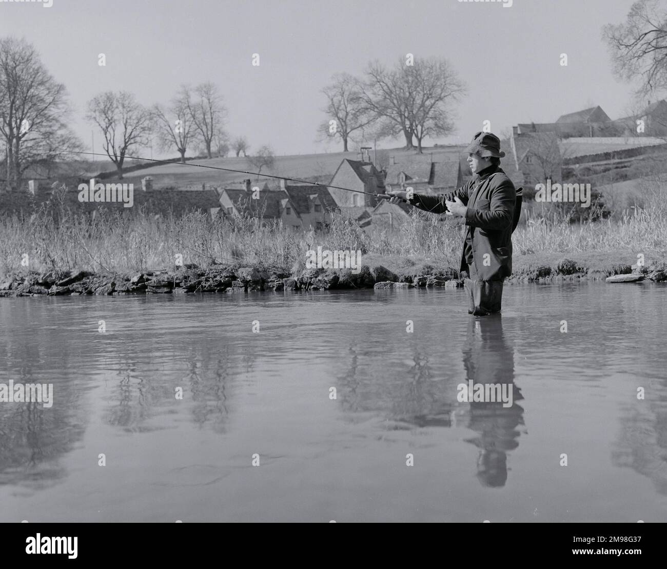 Fly Fisherman fishing in The River Coln Bibury Gloucestershire England ...