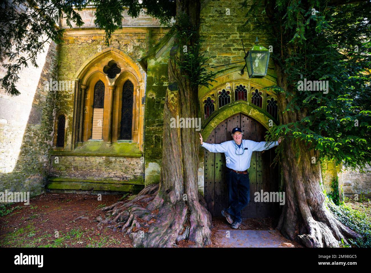 Grade I listed St Edward Church with an ancient door surrounded by yew ...