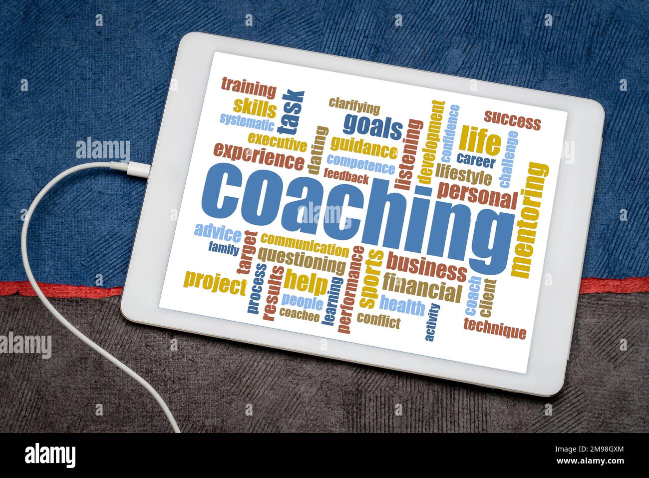 coaching - word cloud on a digital tablet against art paper landscape ...