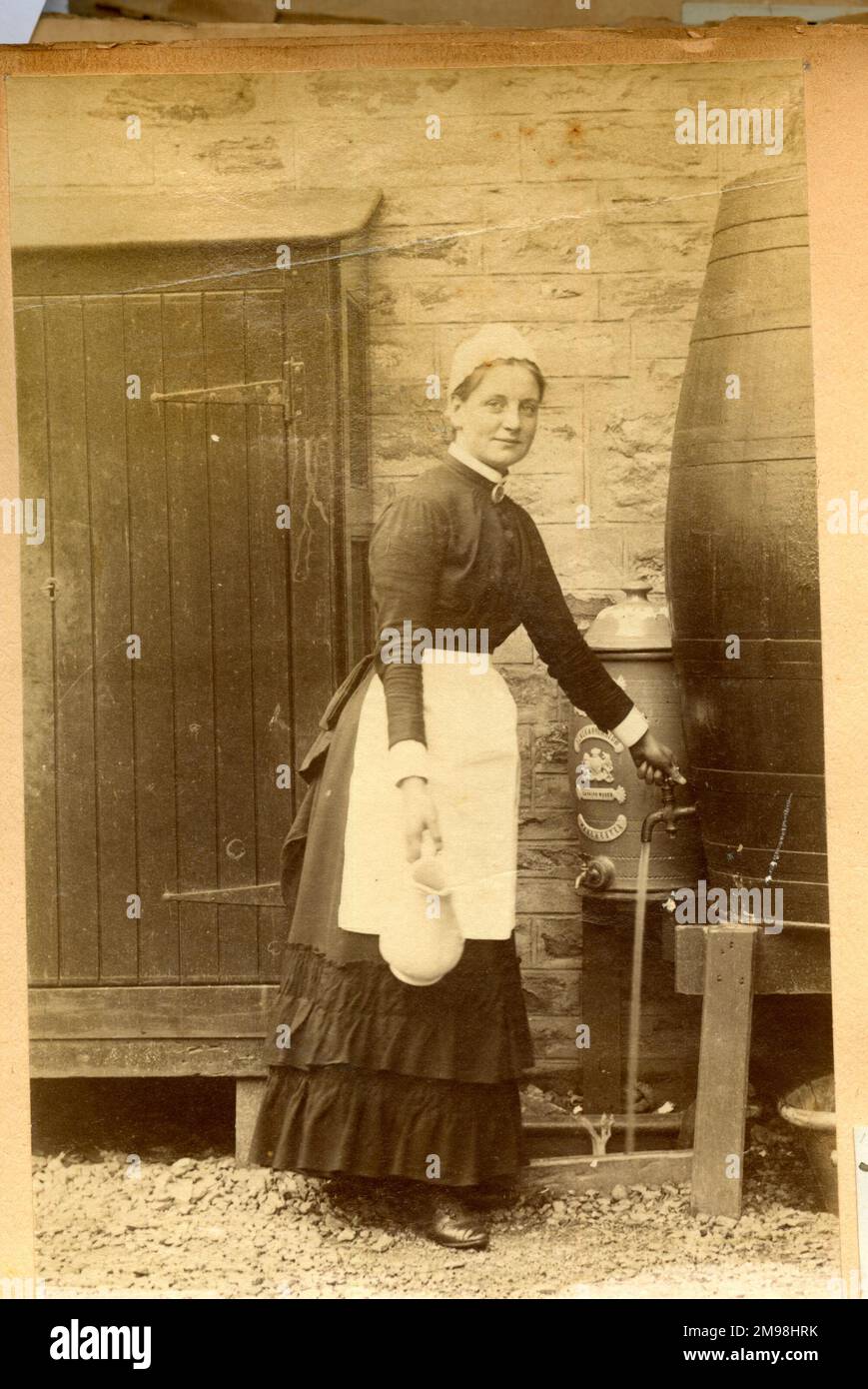 Maid collecting water Stock Photo - Alamy
