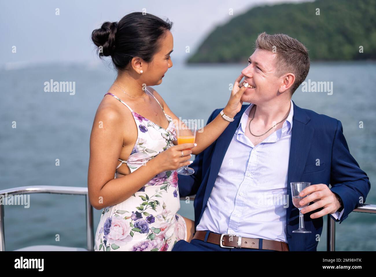 Romantic couple in love have fun sailing in the sea standing on yacht ...