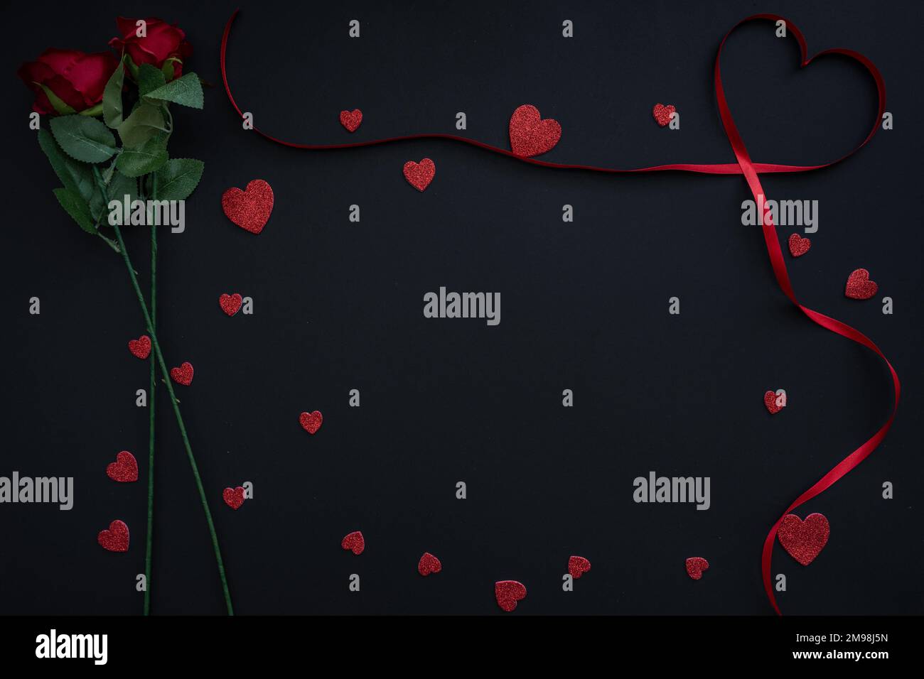 Beautiful valentines day background with red hearts and roses on black ...