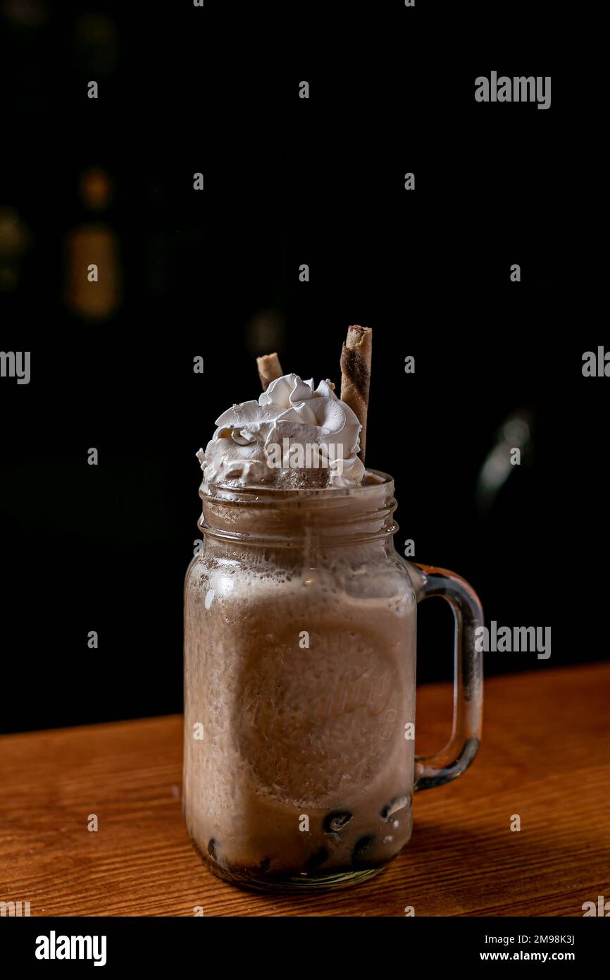A glass of delicious chocolate milkshake on a bar counter Stock Photo ...