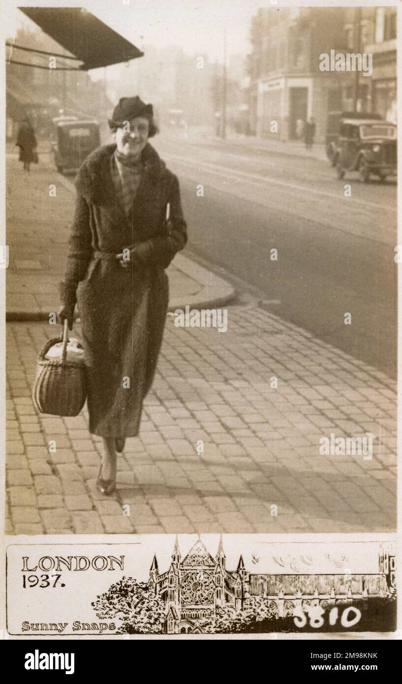 A smart lady ('Marion') strolling along a London Street having been out ...