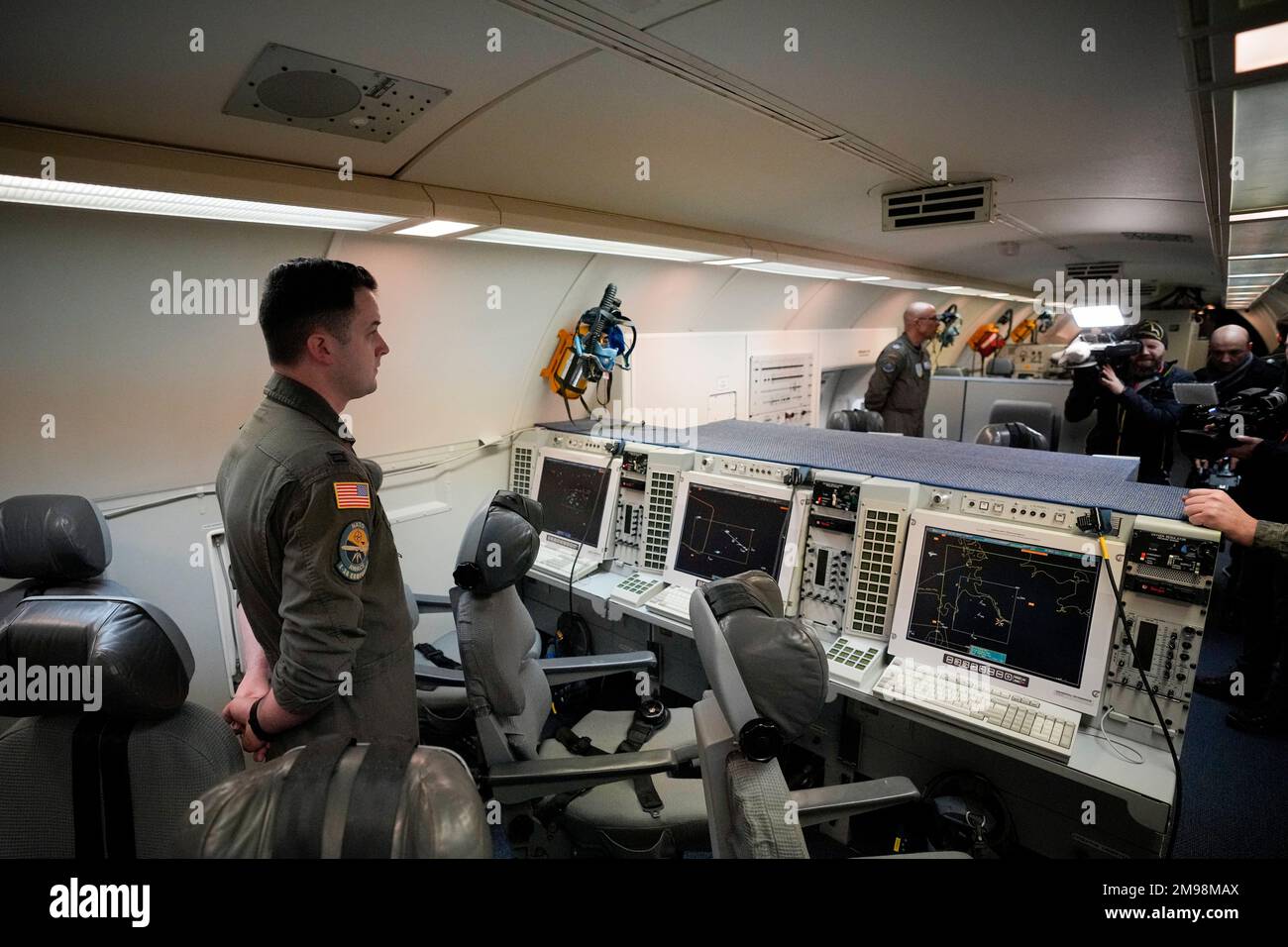 Servicemen stand by workstations inside a NATO AWACS aircraft at the ...