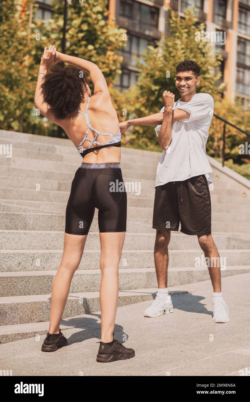 Couple of athletes limbering up before the outdoor workout Stock Photo ...