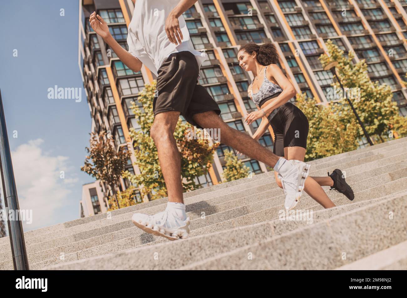 Athletes running together in a residential area Stock Photo - Alamy