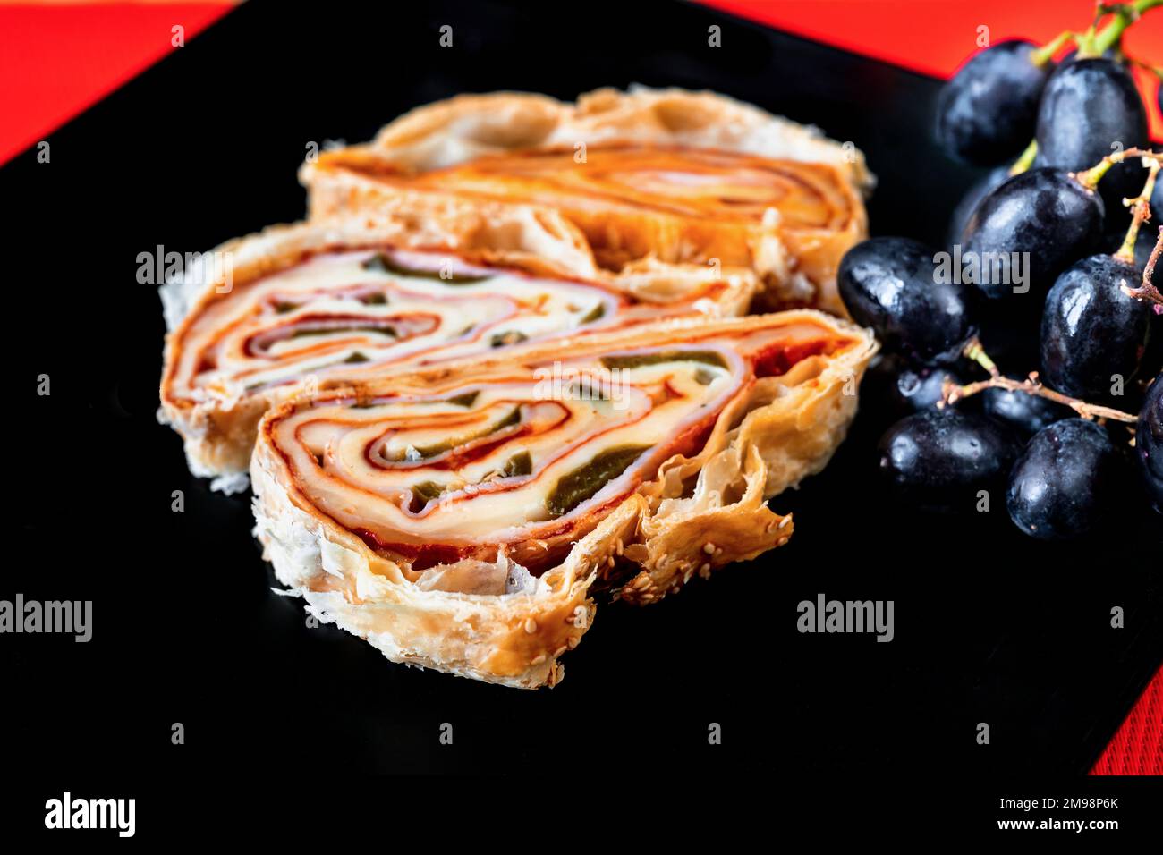 3 piece of sliced salty rolled pastry with ham, cheese and jalapenos ...