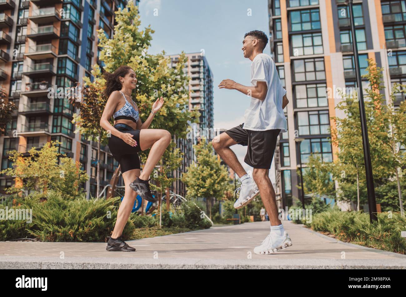 Two sportspeople doing a balance exercise together Stock Photo - Alamy