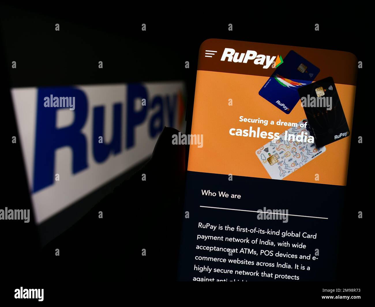 Person holding cellphone with website of Indian payment system RuPay on ...