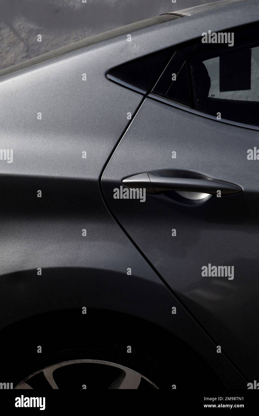 A vertical shot of the door handle of a black car Stock Photo - Alamy