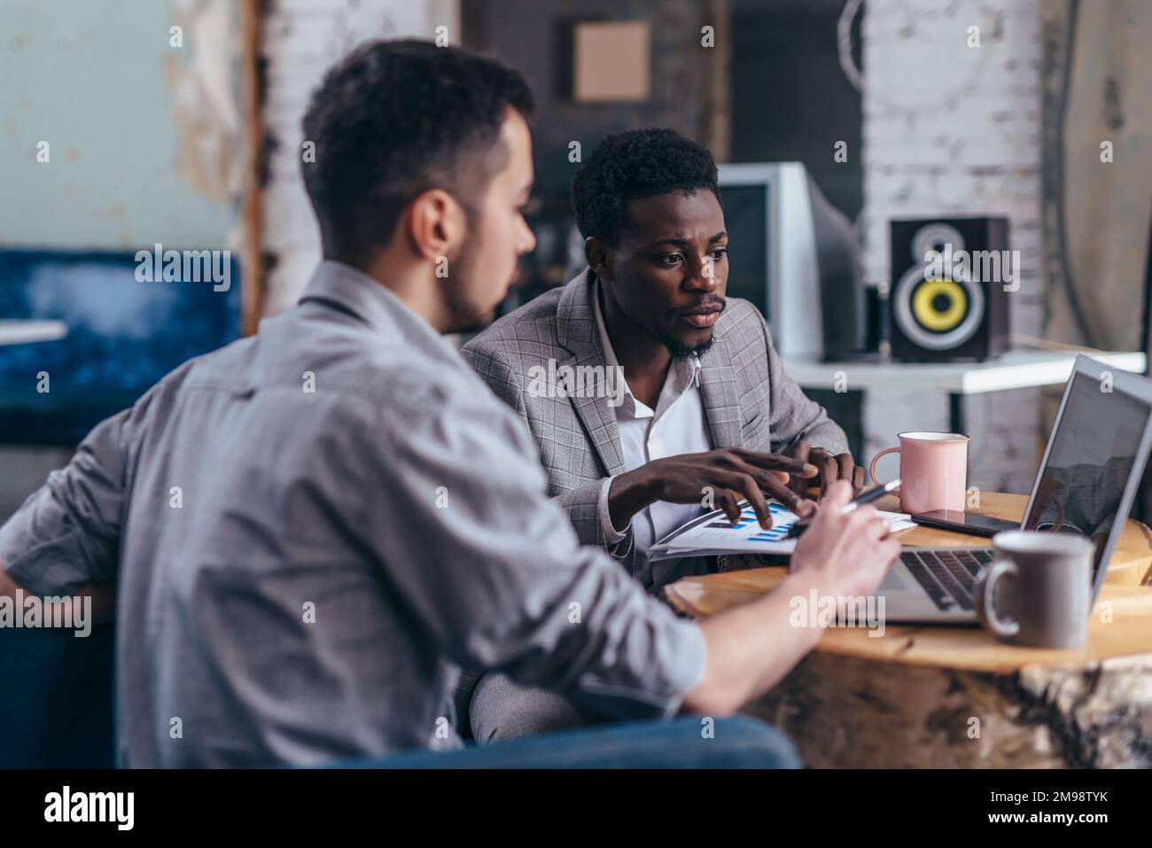 Black executive business owner seated at table with employees Stock ...