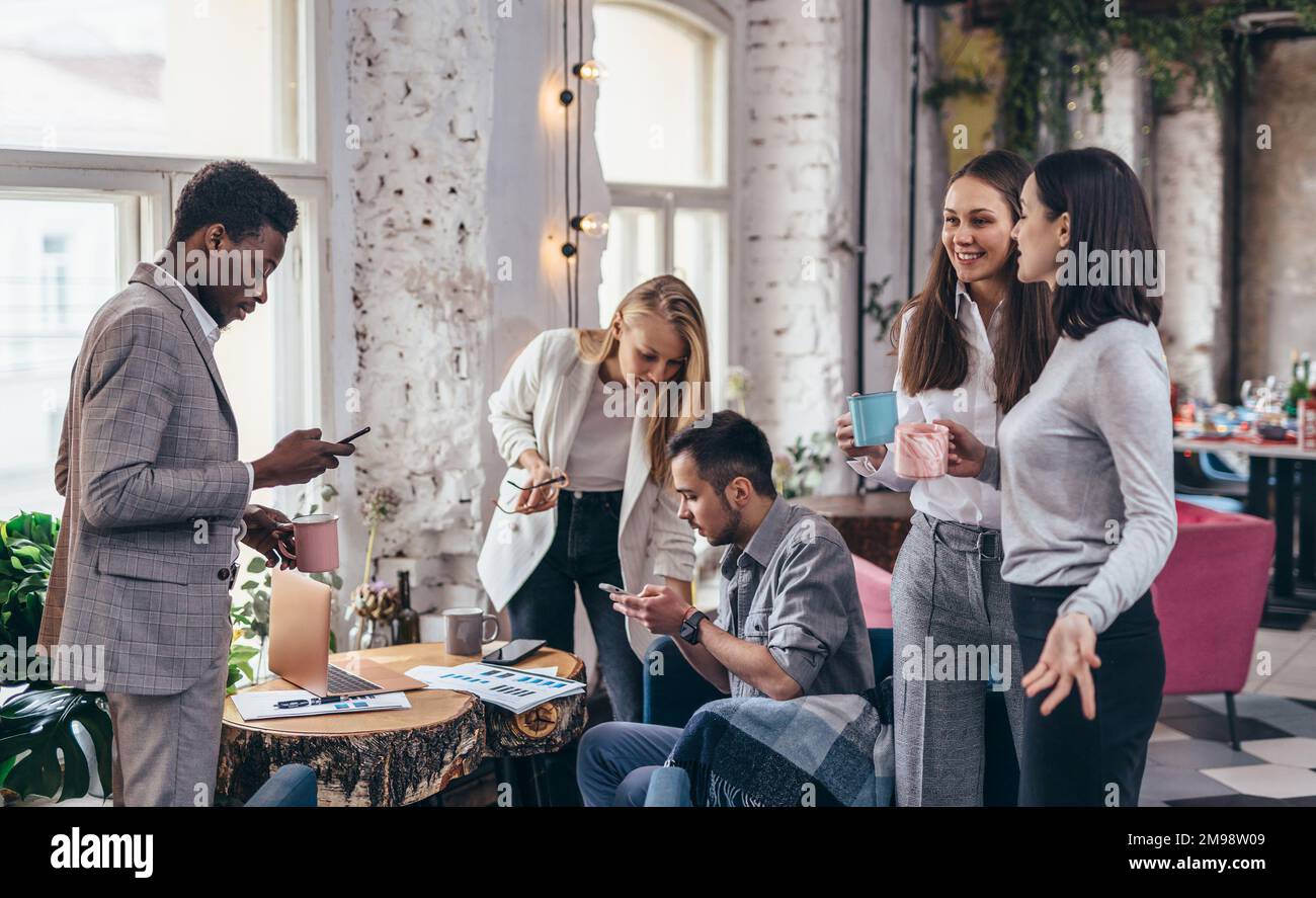 Young people discussing ideas for project in dining room Stock Photo ...