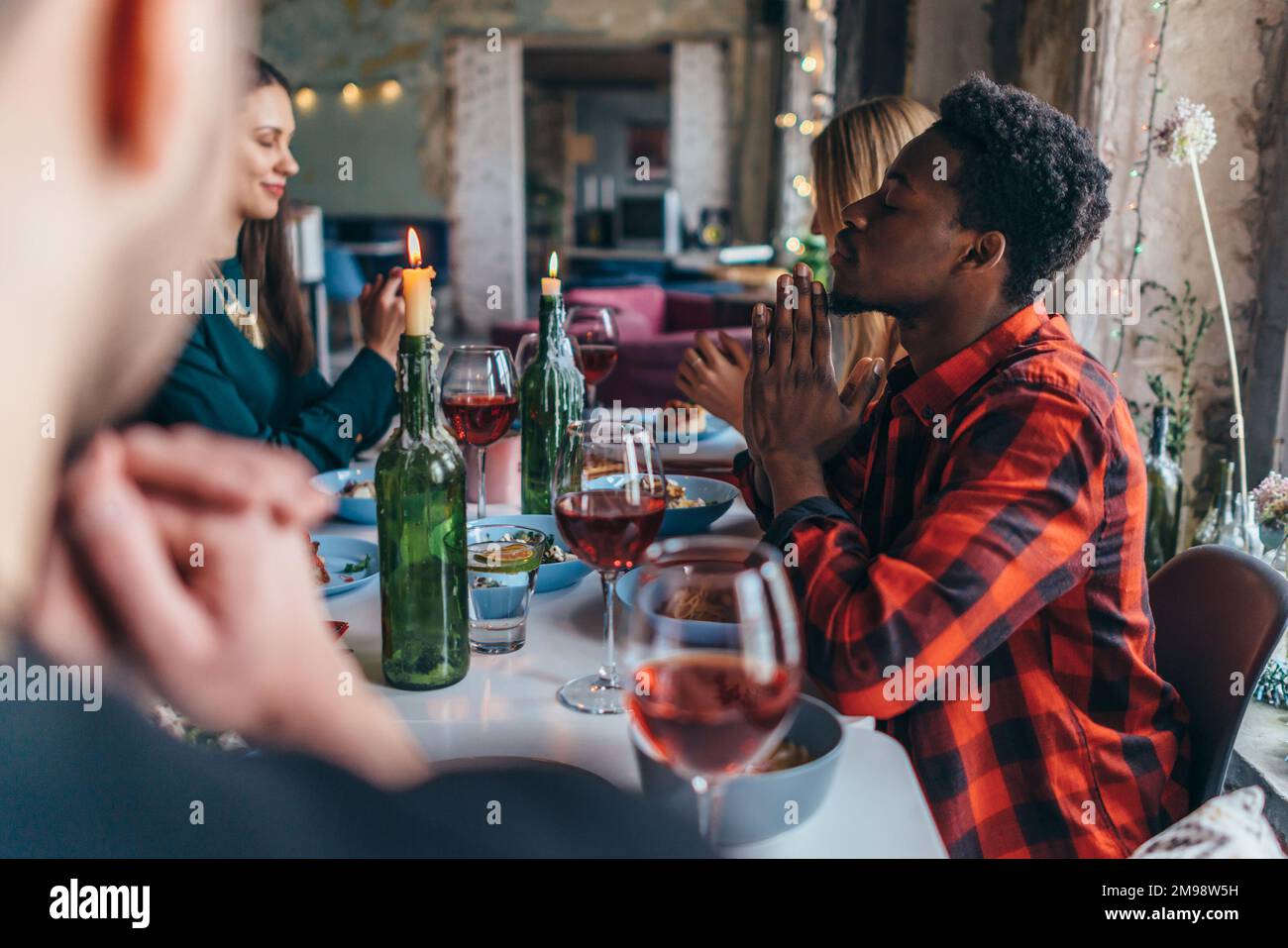 Group Of People Saying Prayers Before Meal Stock Photo - Alamy