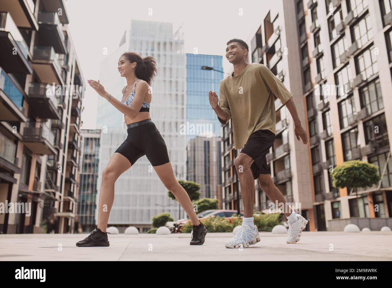 Smiling athletes performing an aerobic exercise together Stock Photo ...