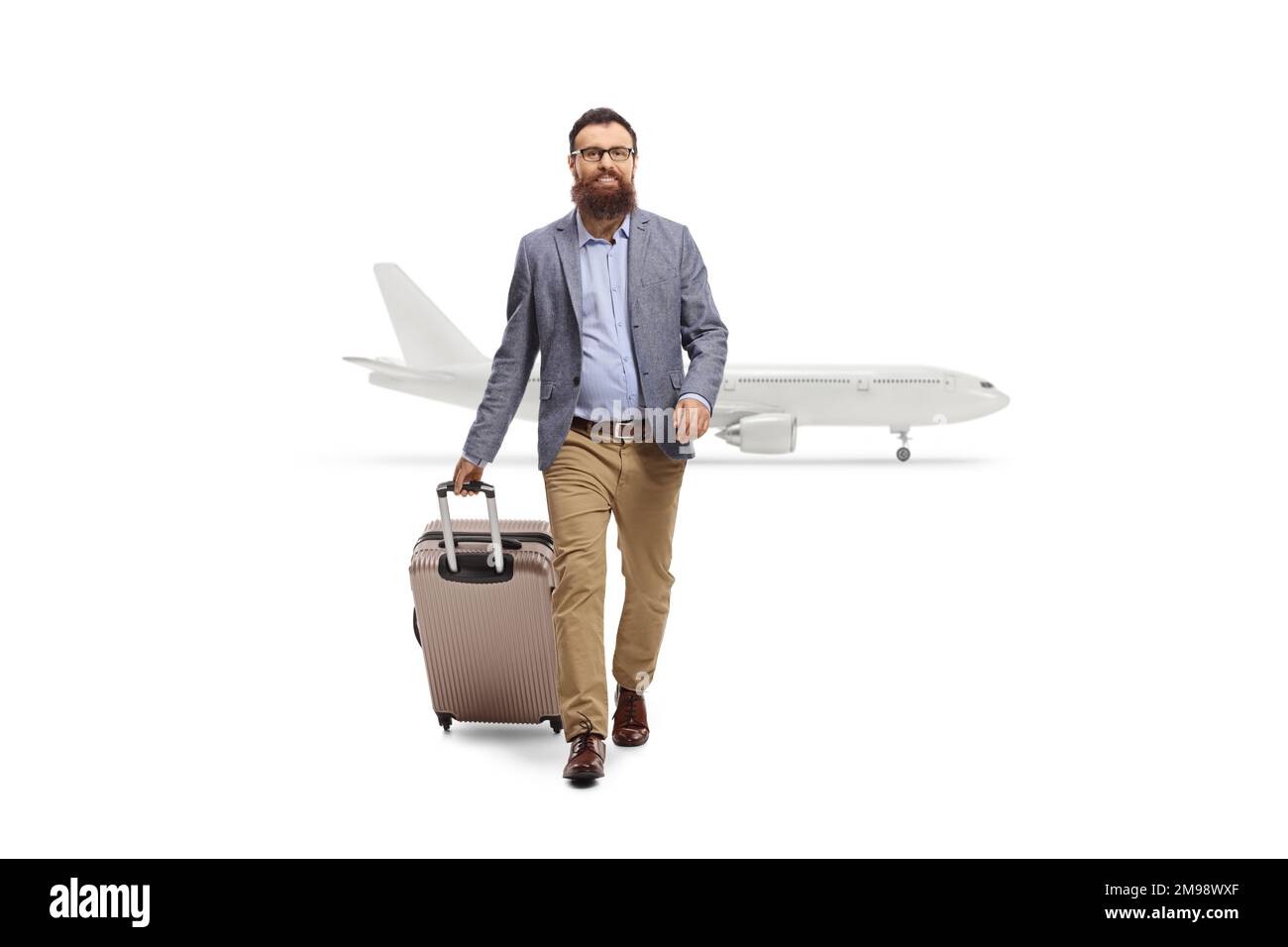 Full length portrait of a man pulling a suitcase and getting off an ...