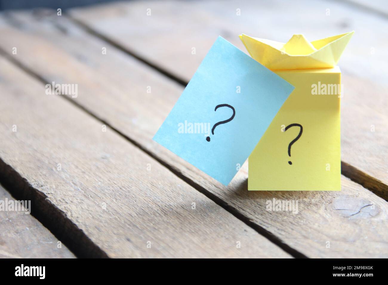 Large Question marks on cards on a wooden background Stock Photo - Alamy
