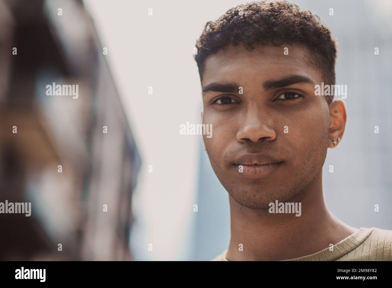 Handsome young man with a double lobe piercing standing outdoors Stock ...