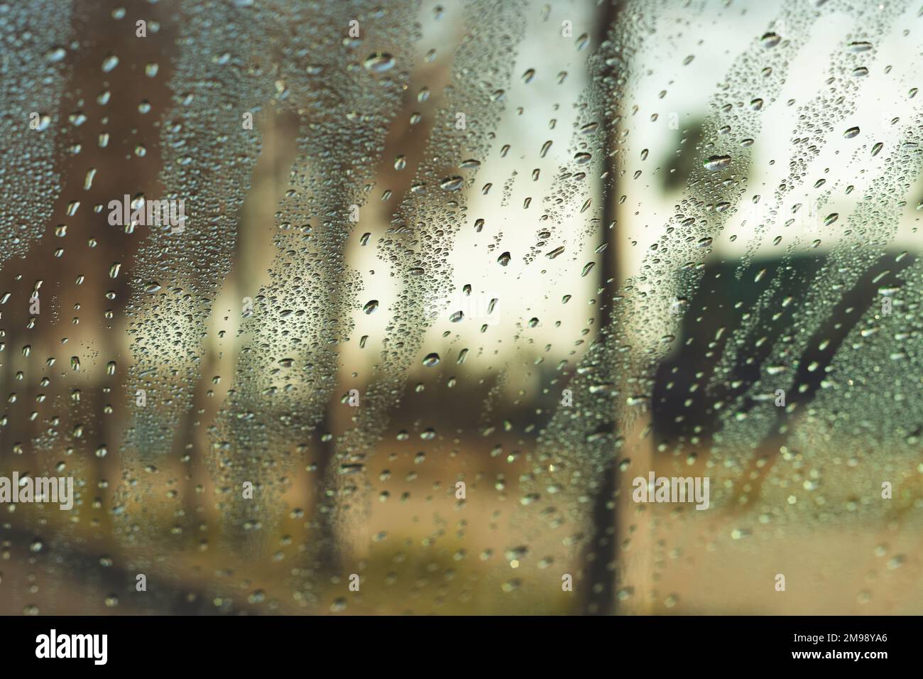 Water drops on vehicle window on rainy day. Through window of car with ...
