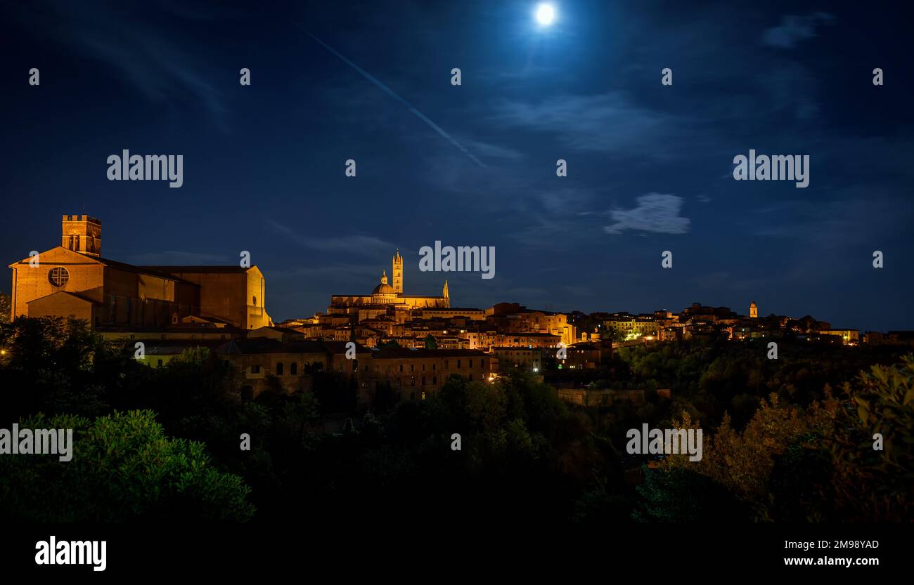 Night, panoramic view of Siena, a medieval town on a hilltop in Tuscany ...