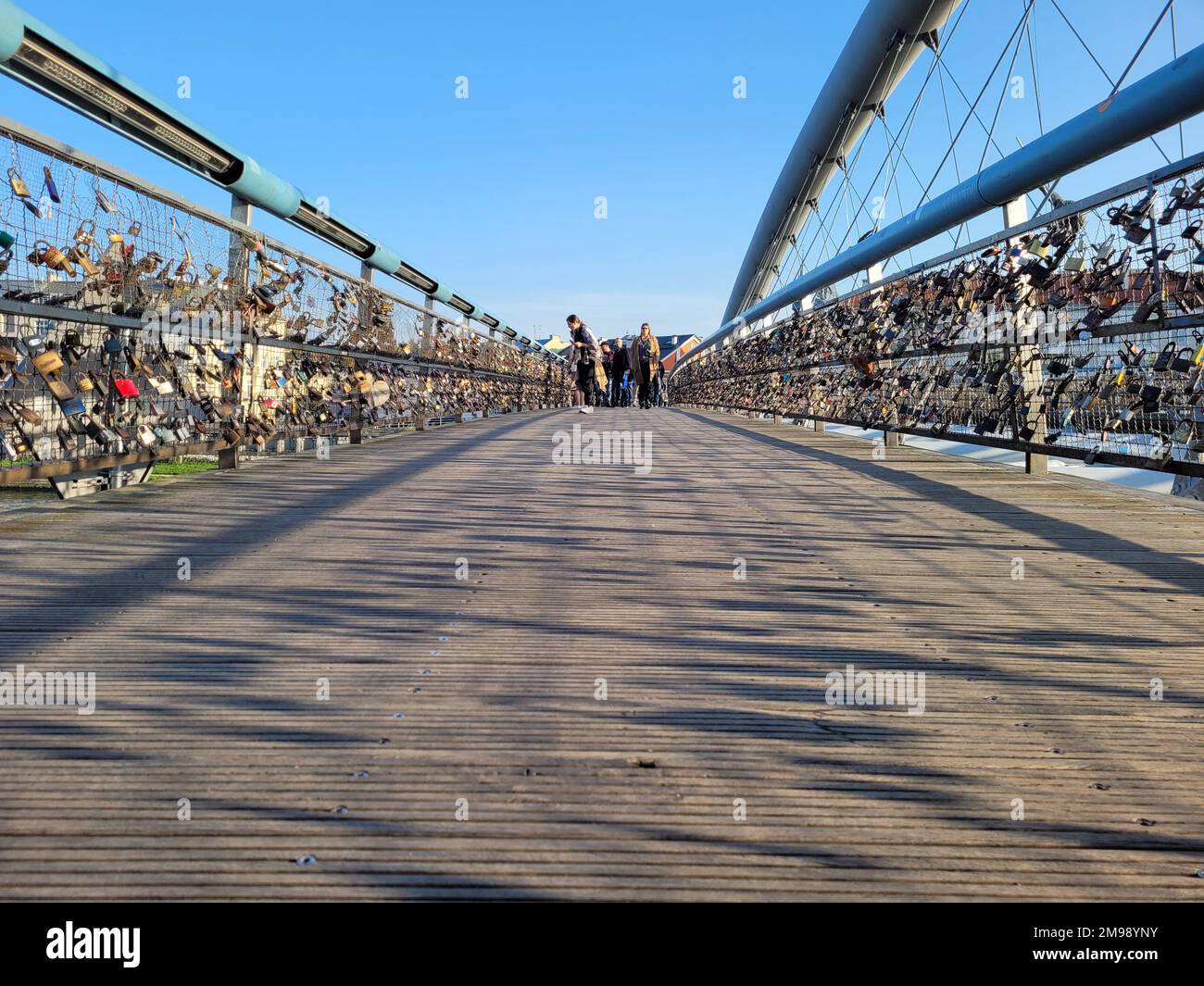 The Bernatek bridge with asphalt ground and many locks fixed to the ...