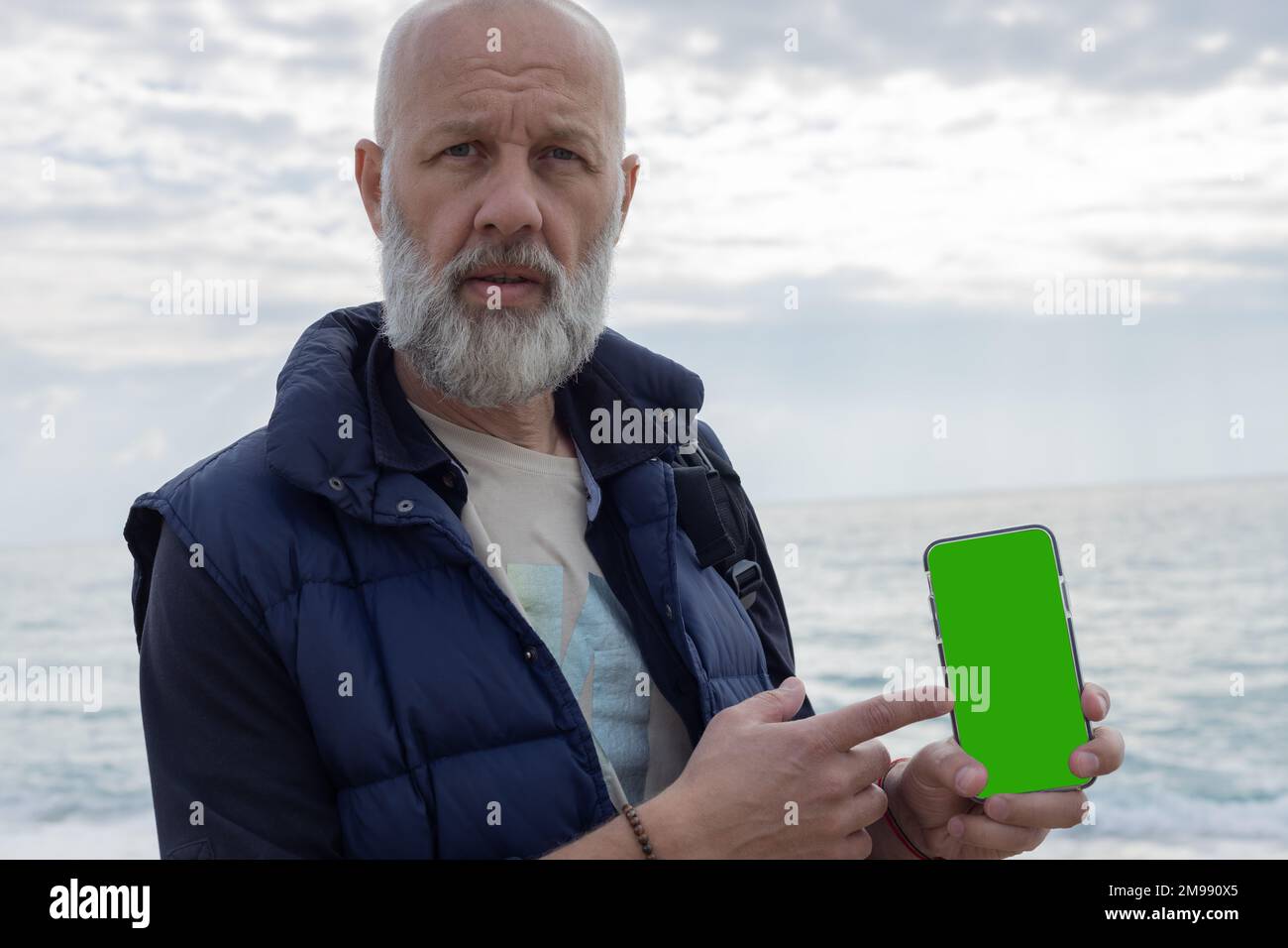 Mockup image of a grey-haired bearded man pointing his finger at a ...