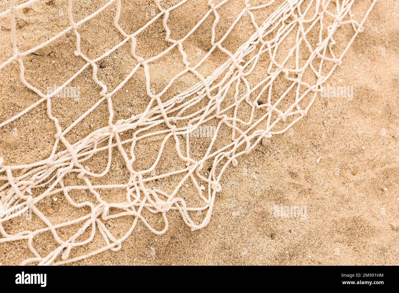 Fishnet on the sand. Fishnet. Woven mesh texture Stock Photo - Alamy