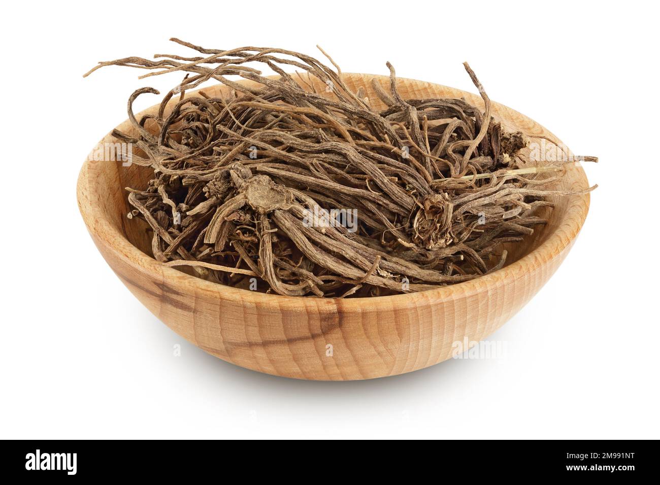 Dried Valerian root in wooden bowl isolated on white background ...