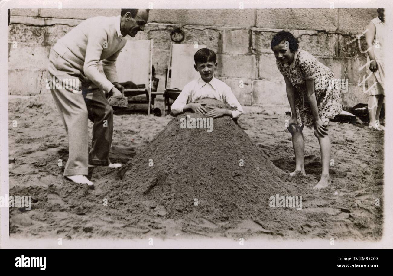 A Father and daughter bury their son/brother in the sand - British ...