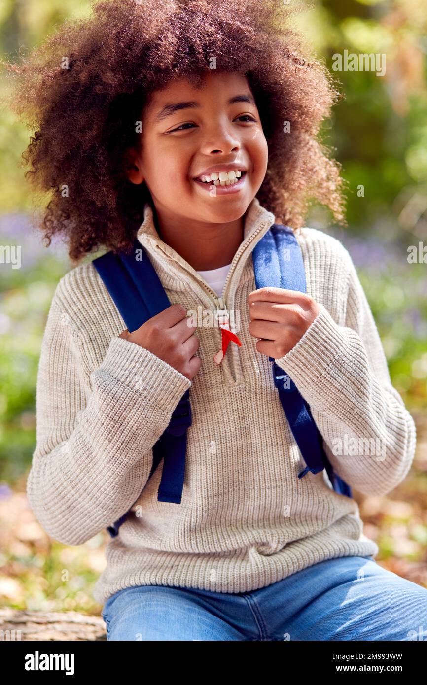 Portrait Of Boy Walking Through Bluebell Woods In Springtime Taking A ...