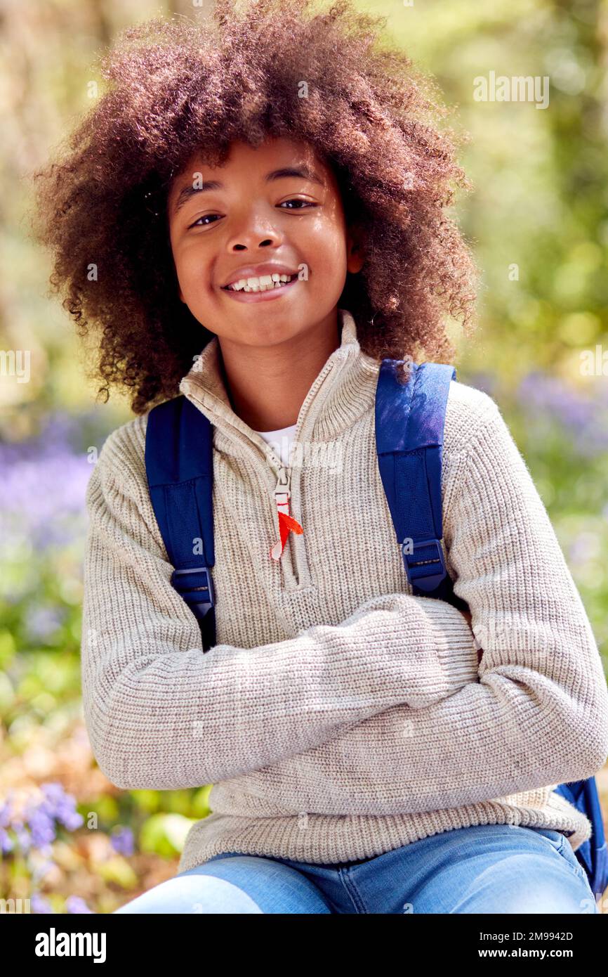 Portrait Of Boy Walking Through Bluebell Woods In Springtime Taking A ...