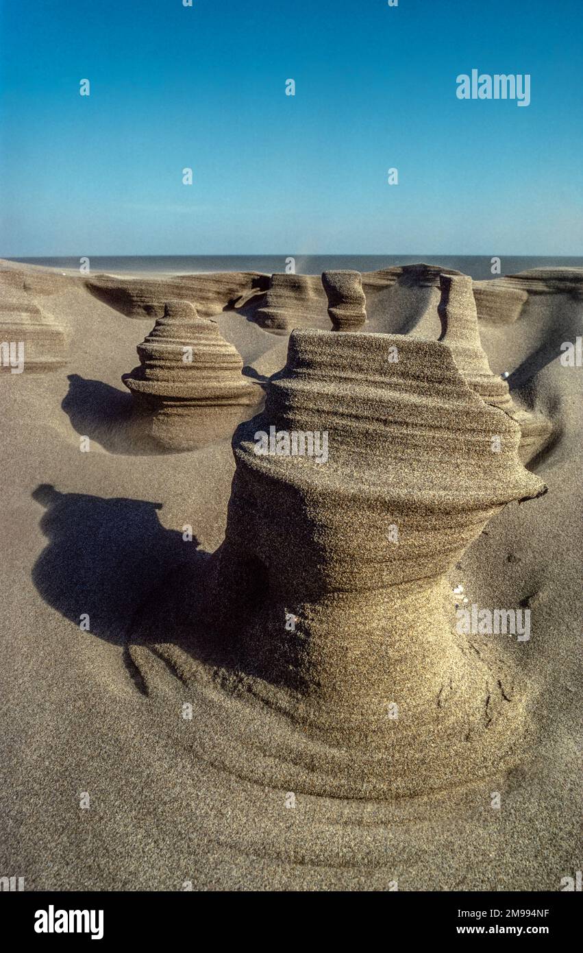 Wind-sculpted sand towers on beach by Mediterranean Sea. Beauduc ...