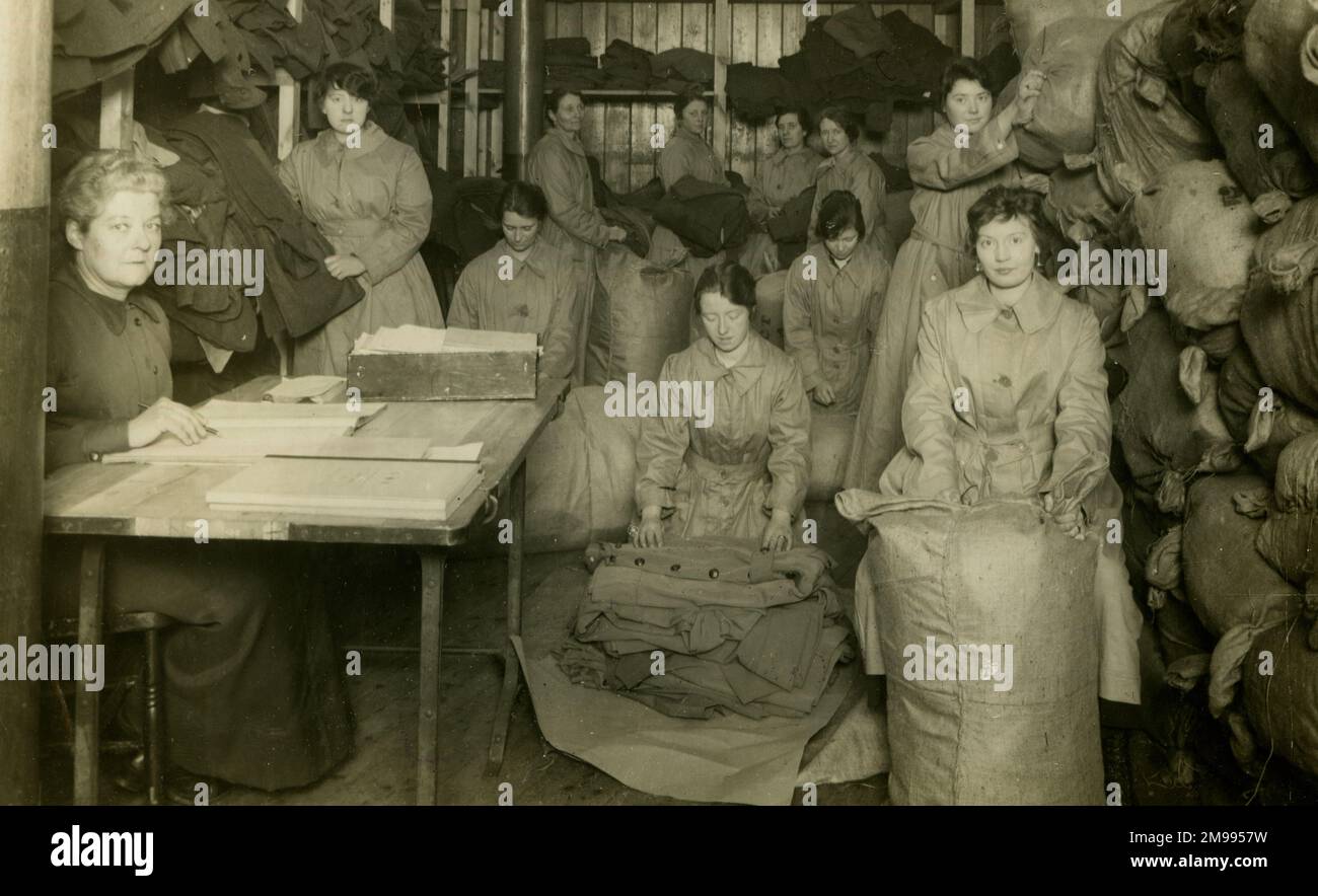 Members of the Women's Auxiliary Army Corps in a clothing store, packing uniforms into bales for ...