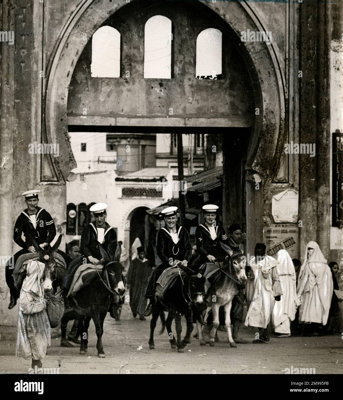 Royal Navy sailors riding on donkeys during a sightseeing tour of the ...