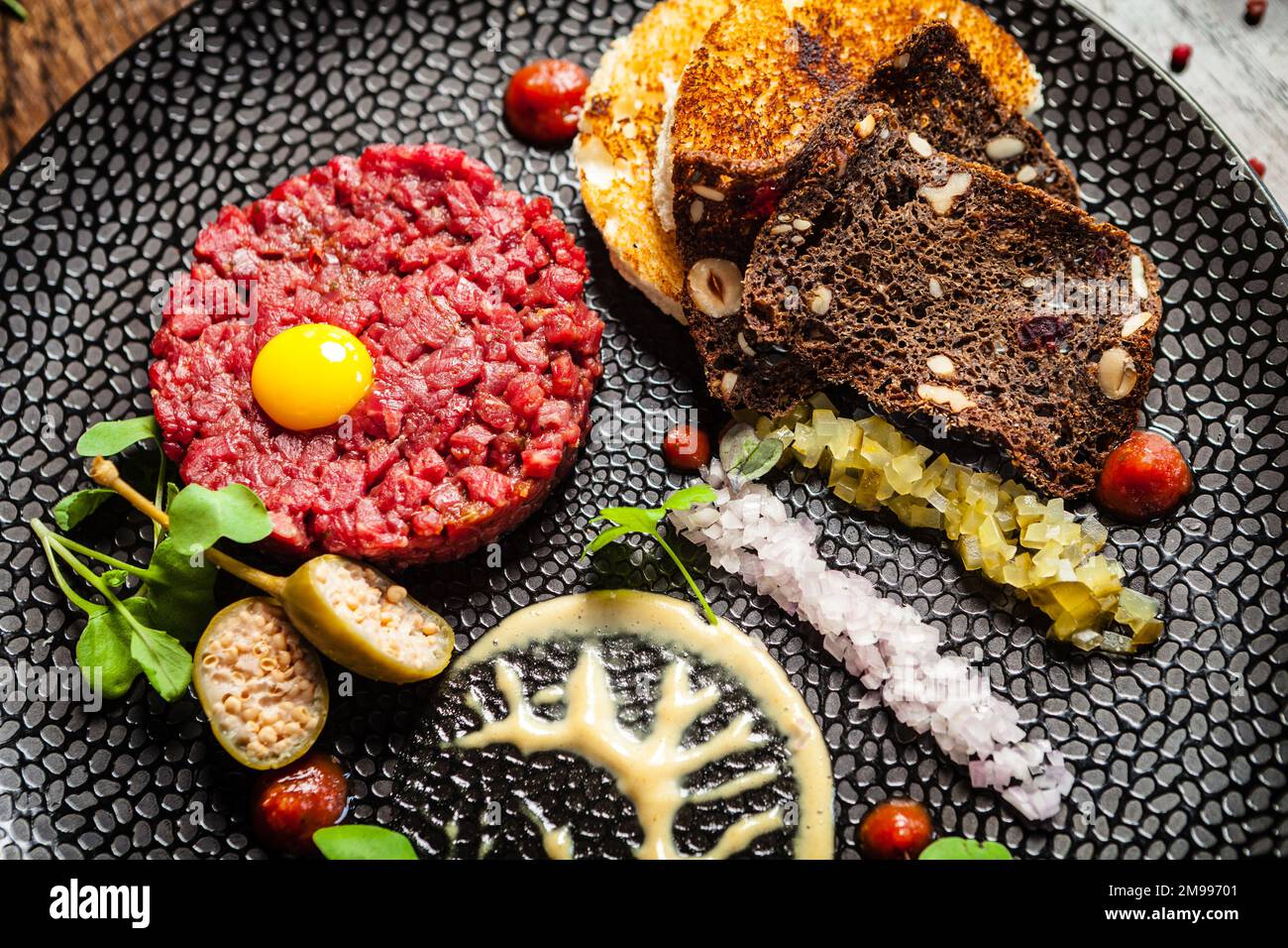 Beef tartare from Black Angus. Onion, quail egg, tomato sauce, mustard ...