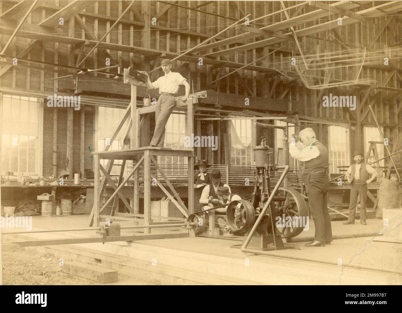 Sir Hiram Maxim operating the valve of the steam engine during a ...